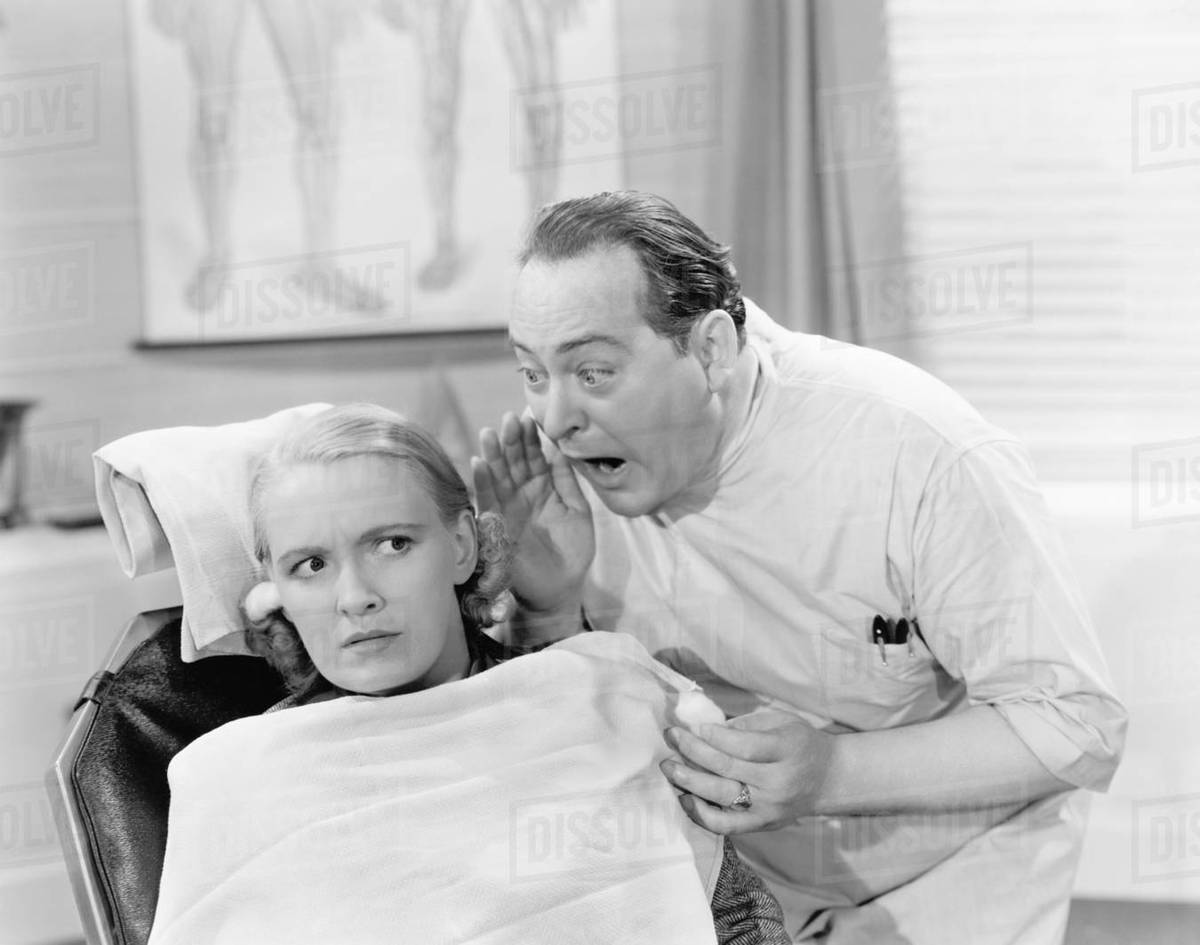 Doctor shouting into the ear of a patient - Royalty-free Stock Photo ...