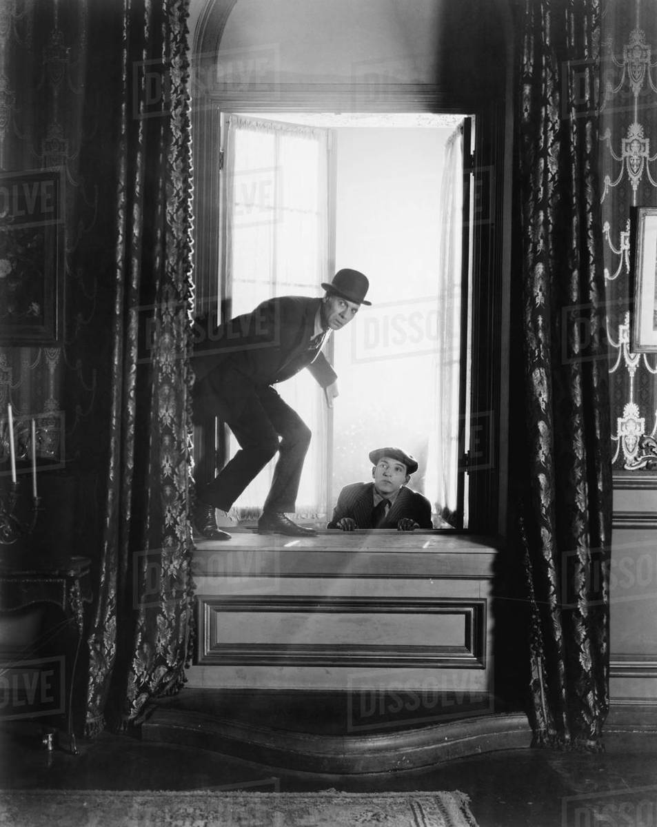 Two men breaking into an apartment - Royalty-free Stock Photo | Dissolve