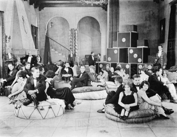 Group of people sitting on oversized cushions in a hall - Stock Photo ...