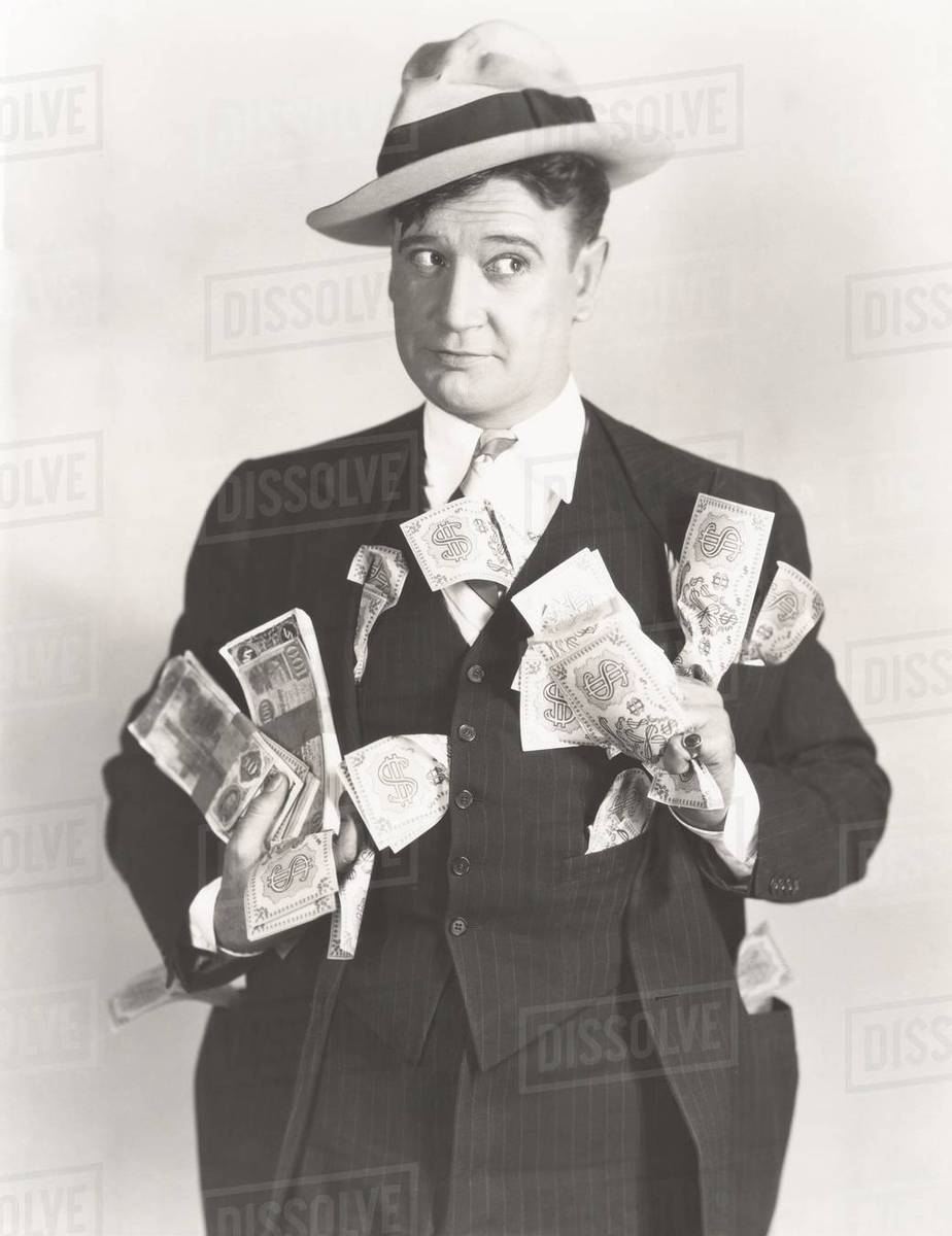 Man holding wads of fake money - Royalty-free Stock Photo | Dissolve
