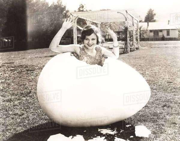Woman popping out of giant egg - Royalty-free Stock Photo | Dissolve