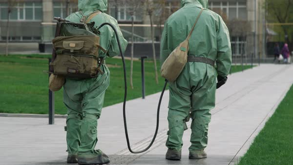 People in bio viral hazard protective suits. Disinfection and ...