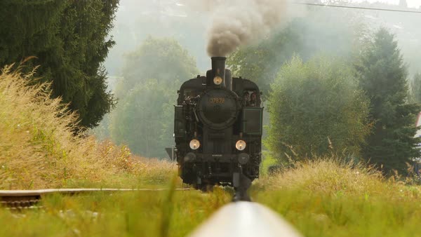 Industrial steam engine train locomotive riding on railroad track in ...