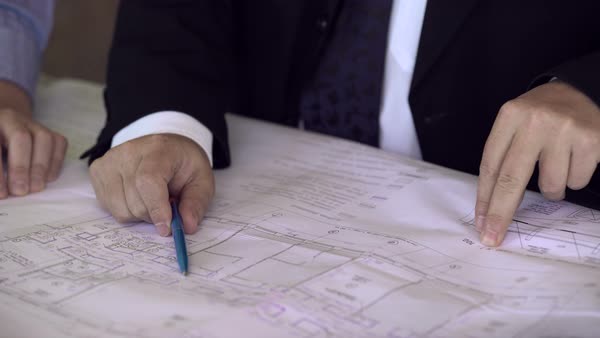 Looking at blueprints on construction site - Stock Video Footage - Dissolve