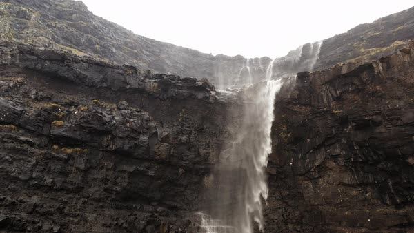 Drone Flight Out Of Cascading Water From Rocky Fossa Waterfall, Faroe ...