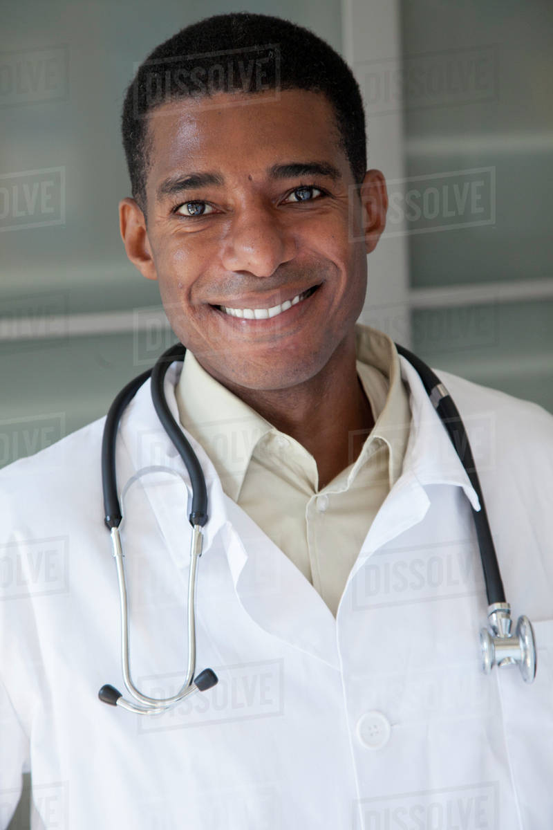 Smiling Black doctor in lab coat - Royalty-free Stock Photo | Dissolve