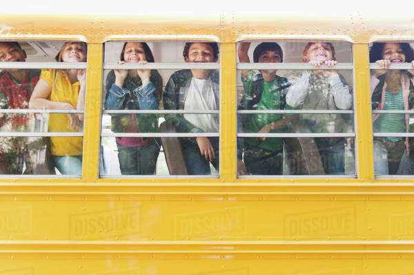 Children riding school bus - Stock Photo - Dissolve
