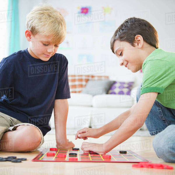 Boys sitting on floor playing checkers - Royalty-free Stock Photo ...