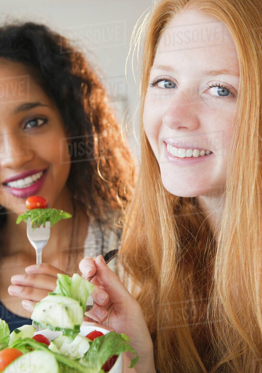Friends eating salad together - Stock Photo - Dissolve