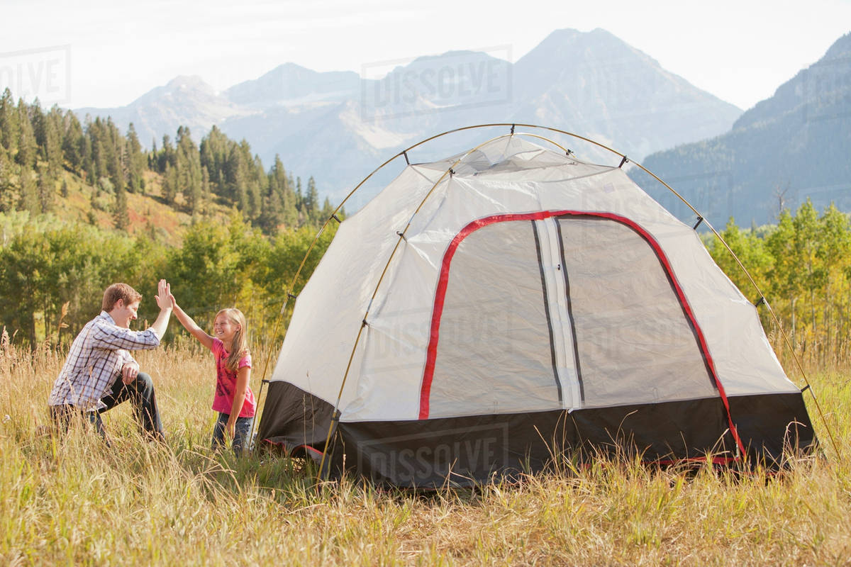 Caucasian father and daughter setting up tent - Royalty-free Stock ...