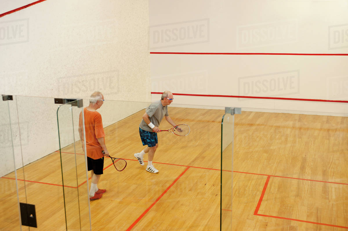 Hispanic men playing racquetball - Stock Photo - Dissolve