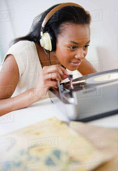 Black woman listening to record player - Royalty-free Stock Photo ...