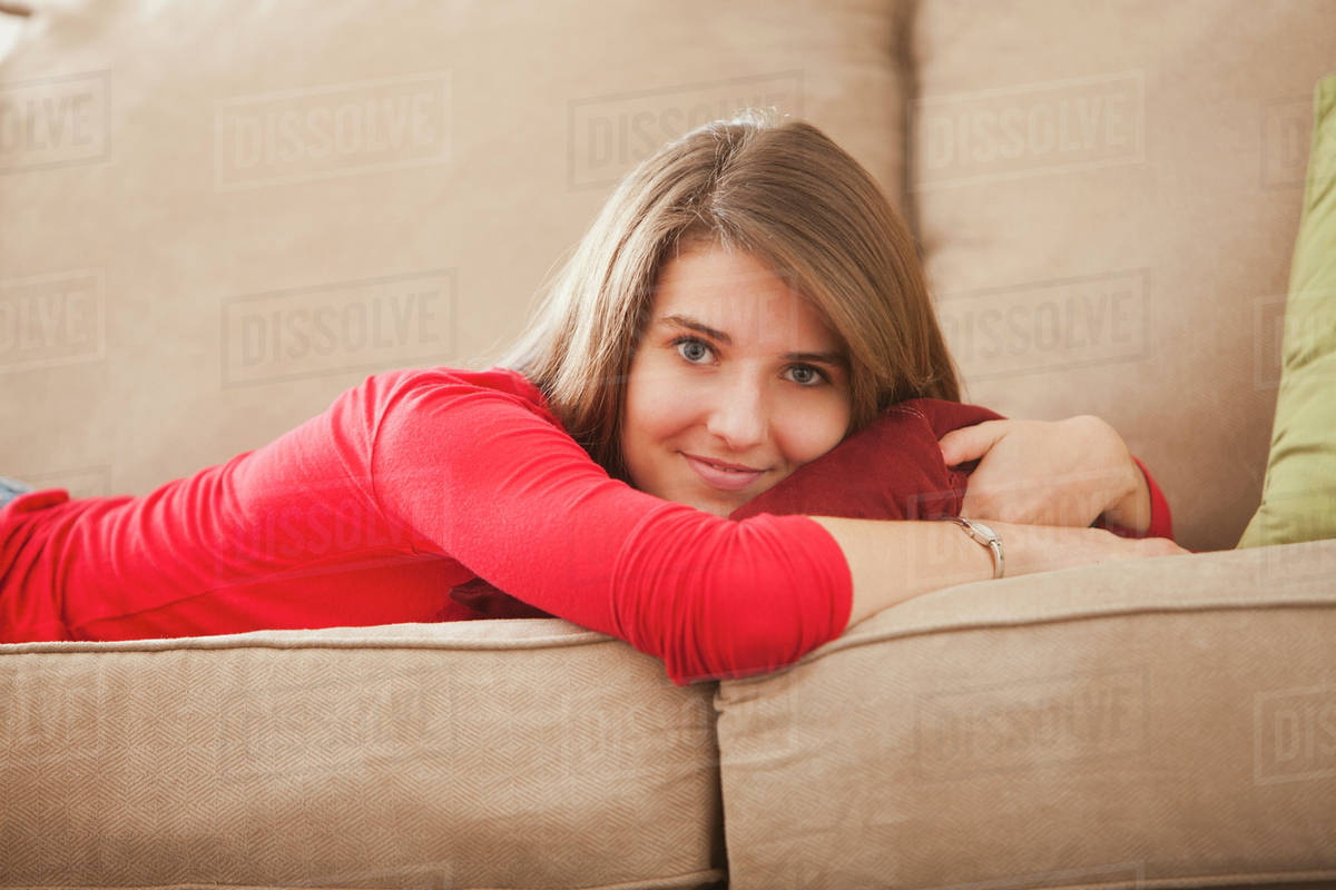 Caucasian woman laying on sofa - Royalty-free Stock Photo | Dissolve
