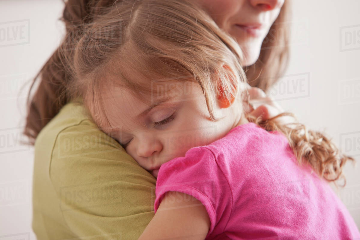 Caucasian mother carrying sleeping daughter - Royalty-free Stock Photo ...