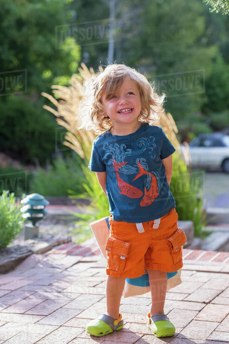 Caucasian toddler hiding gift behind back - Royalty-free Stock Photo ...