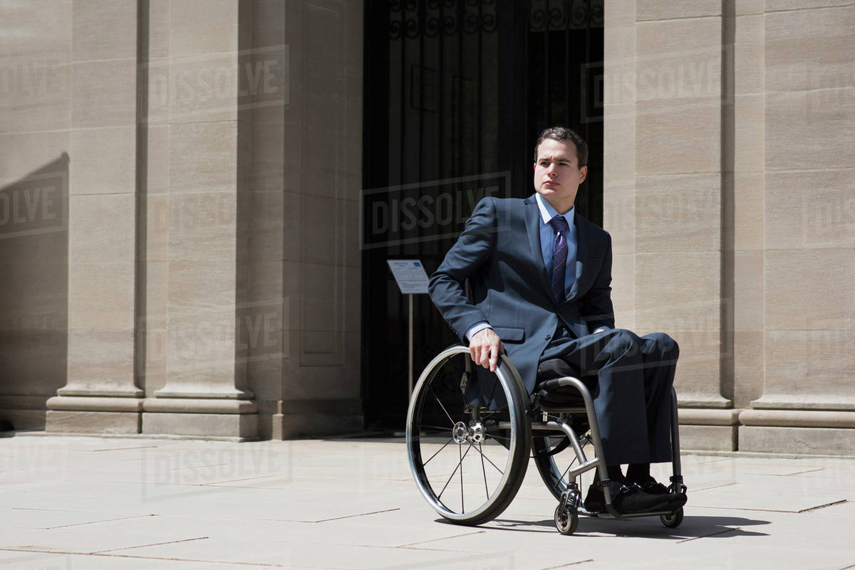 Paraplegic businessman sitting in wheelchair - Royalty-free Stock Photo ...