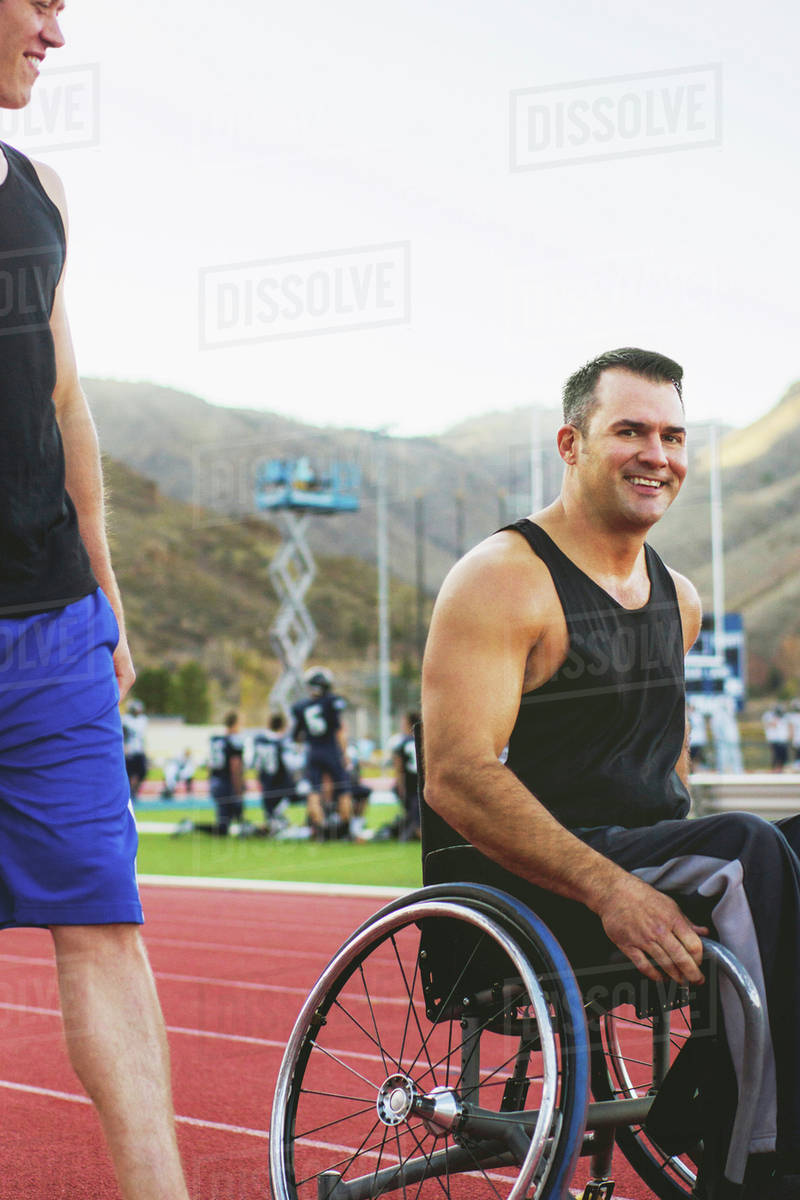 Paraplegic athlete in wheelchair and friend on track - Royalty-free ...