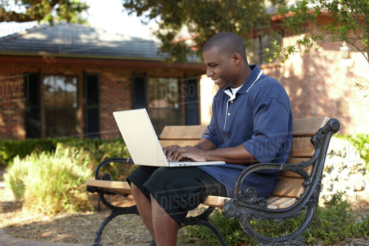 Black man typing on laptop - Royalty-free Stock Photo | Dissolve