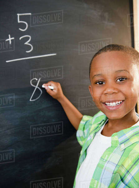 Black boy solving math problems on blackboard - Royalty-free Stock ...