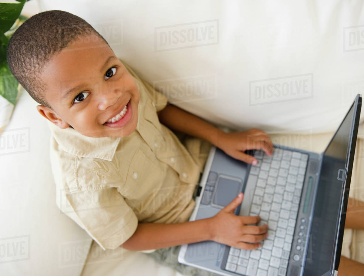 African American boy using laptop - Royalty-free Stock Photo | Dissolve