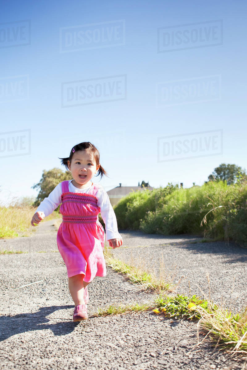 Girl running on path - Royalty-free Stock Photo | Dissolve