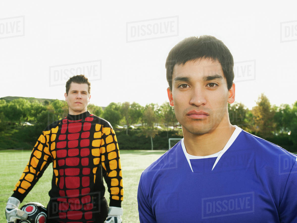 Soccer players standing on soccer field - Stock Photo - Dissolve