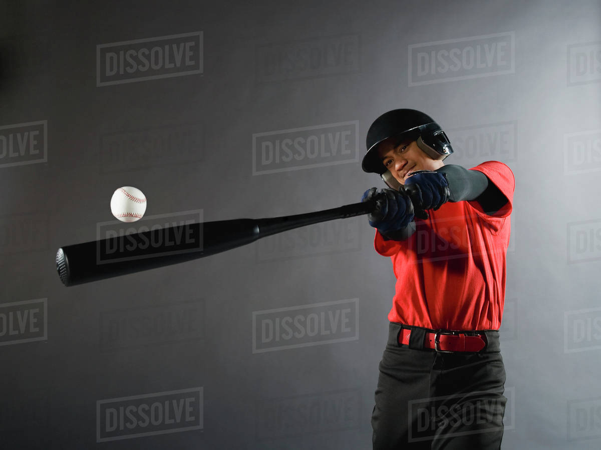 Mixed race baseball player swinging bat - Royalty-free Stock Photo ...