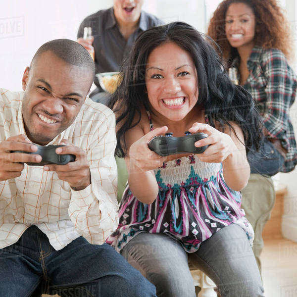 Man and woman playing video game and making faces - Royalty-free Stock ...