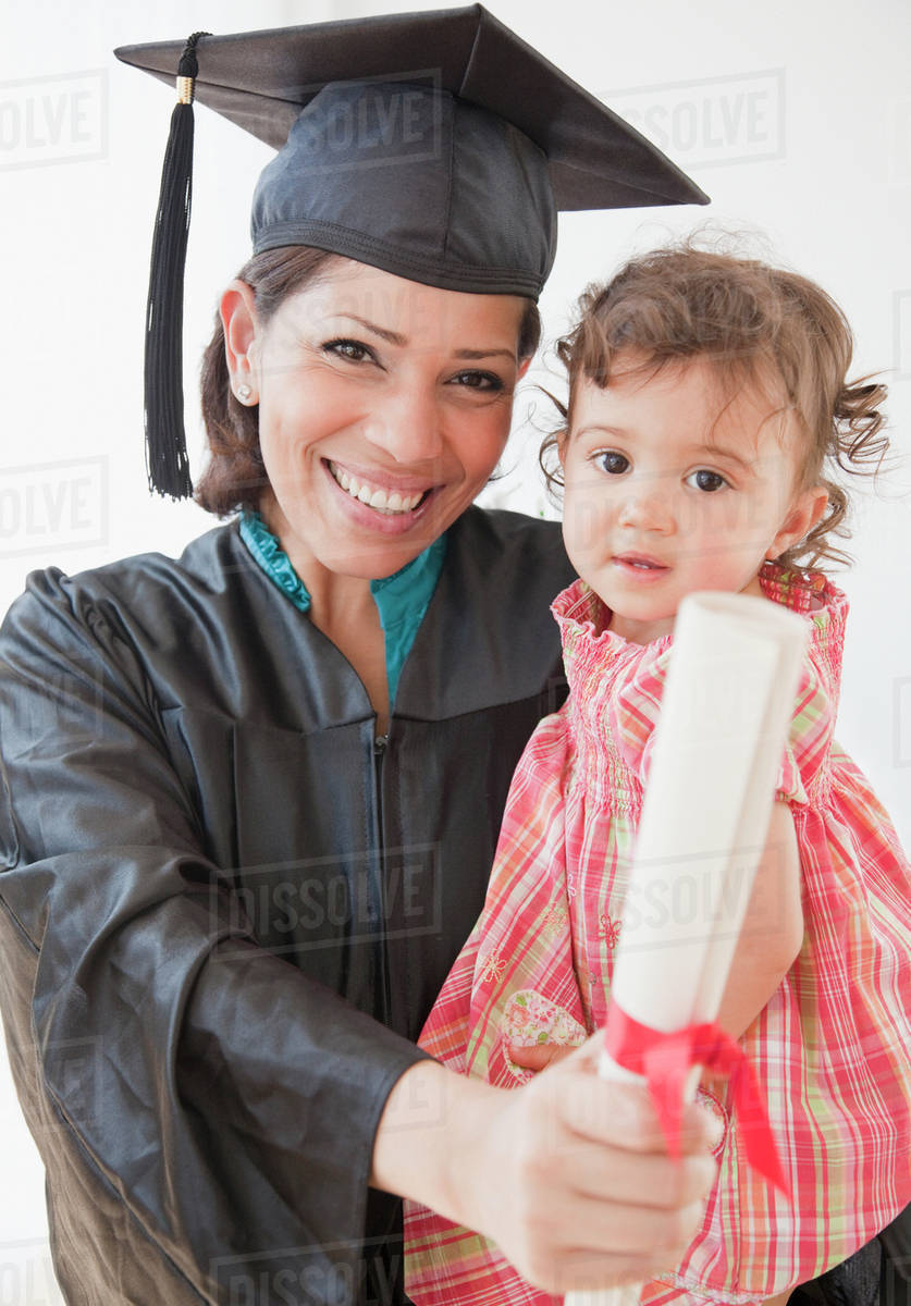 Hispanic mother graduate holding daughter and diploma - Stock Photo ...