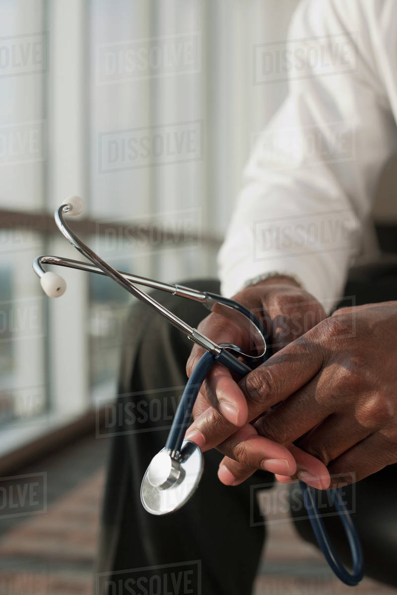 African American doctor holding stethoscope - Royalty-free Stock Photo ...