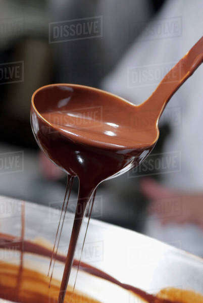 Melted chocolate dripping from ladle - Royalty-free Stock Photo | Dissolve