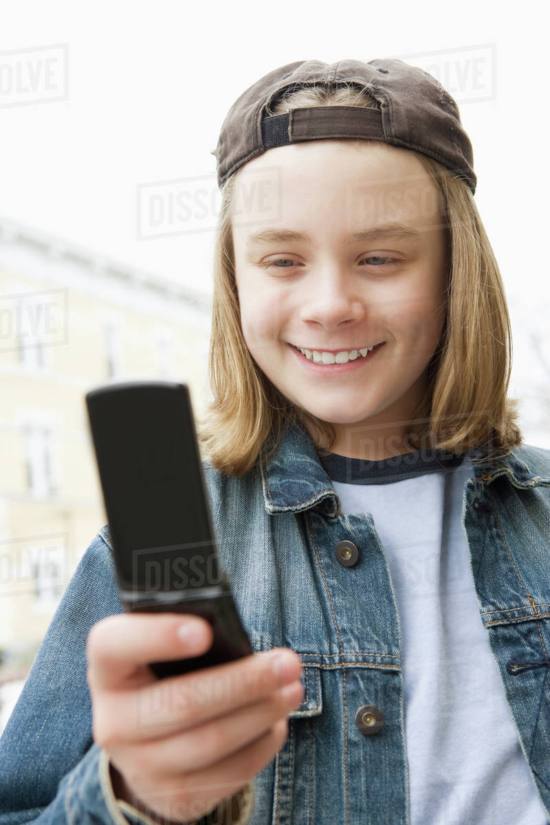 Caucasian boy text messaging on cell phone - Royalty-free Stock Photo ...