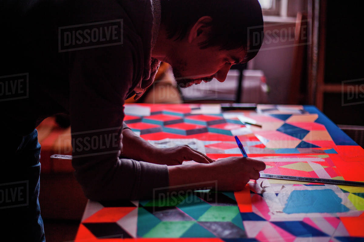 Mari man designing colorful table - Stock Photo - Dissolve