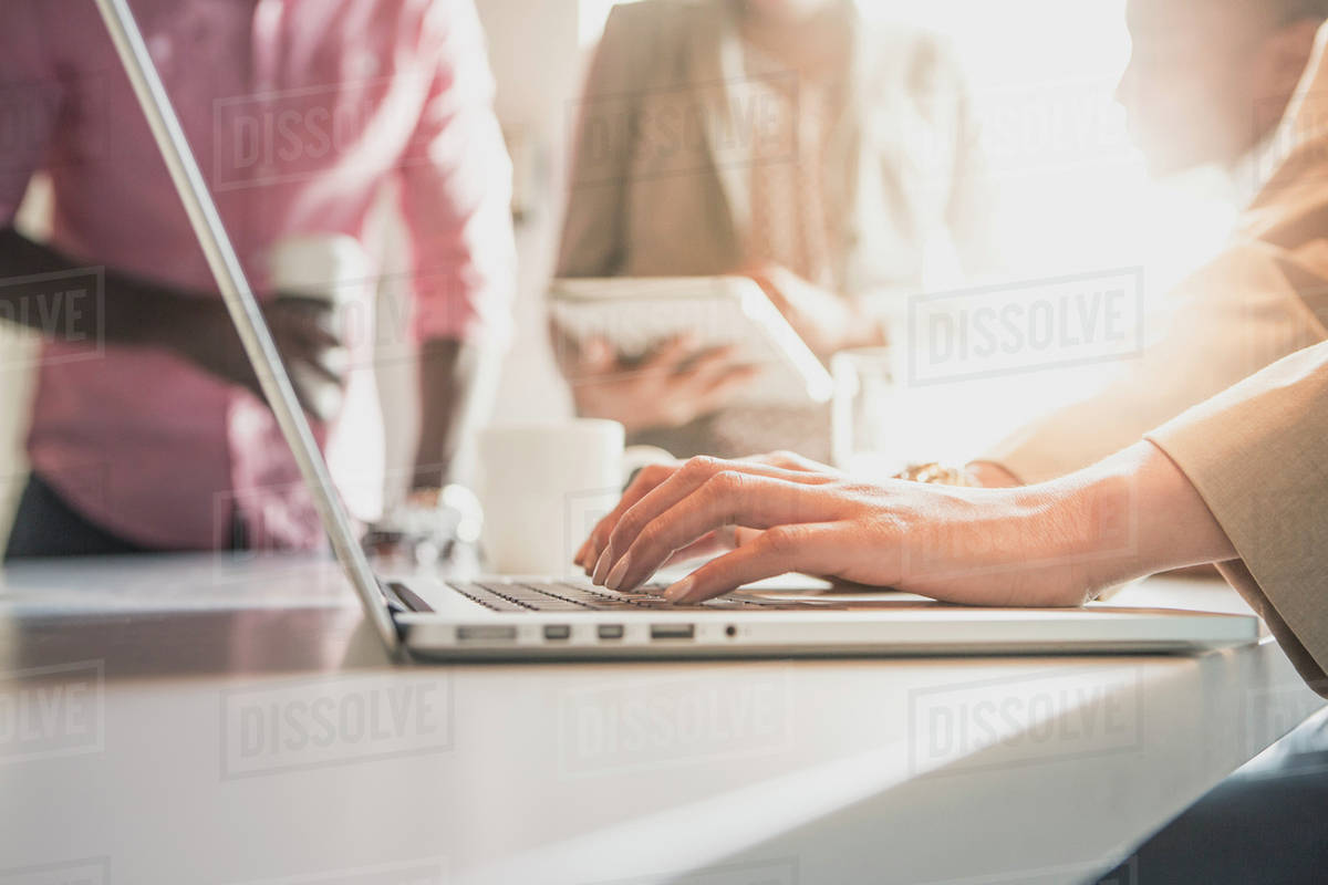 Businesswoman using laptop in office - Royalty-free Stock Photo | Dissolve