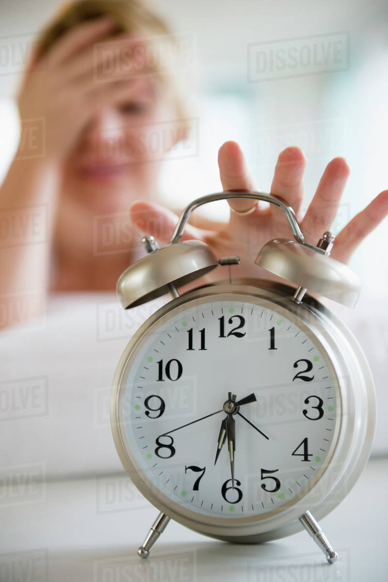 Caucasian woman shutting off alarm clock - Royalty-free Stock Photo ...