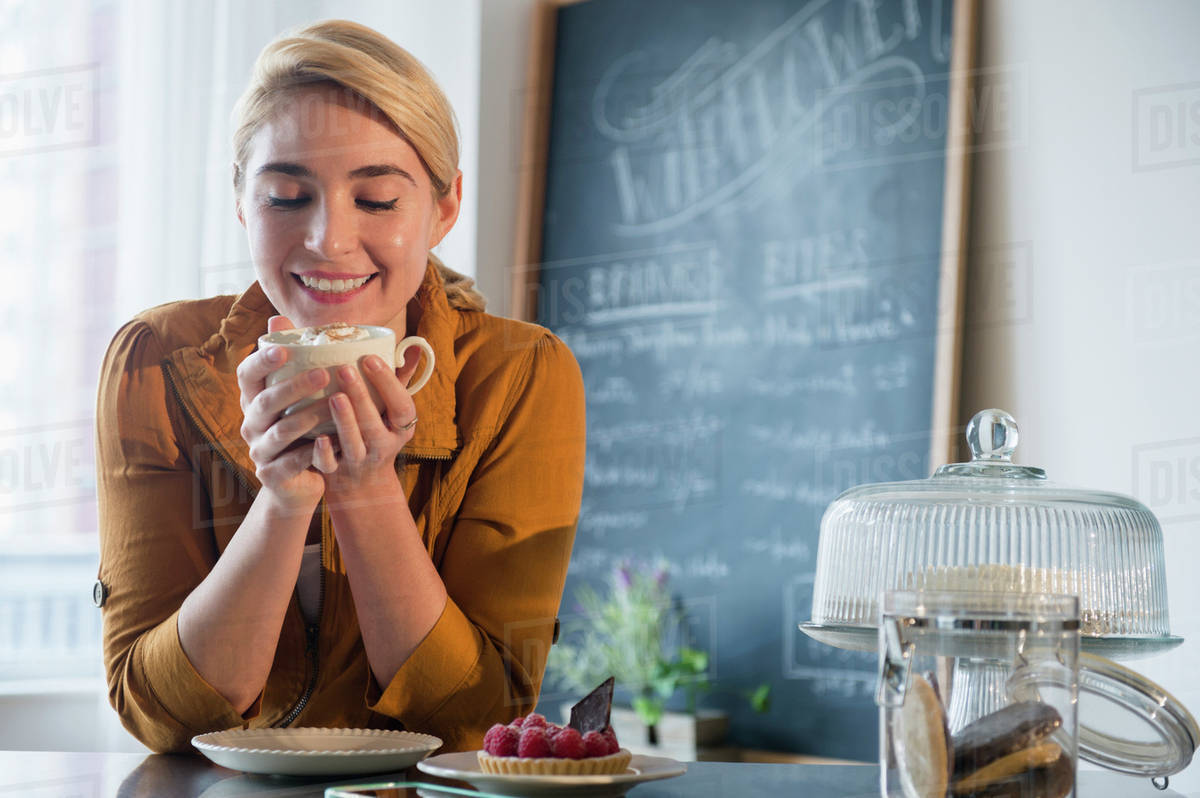 Caucasian woman smelling cup of coffee in cafe - Royalty-free Stock ...