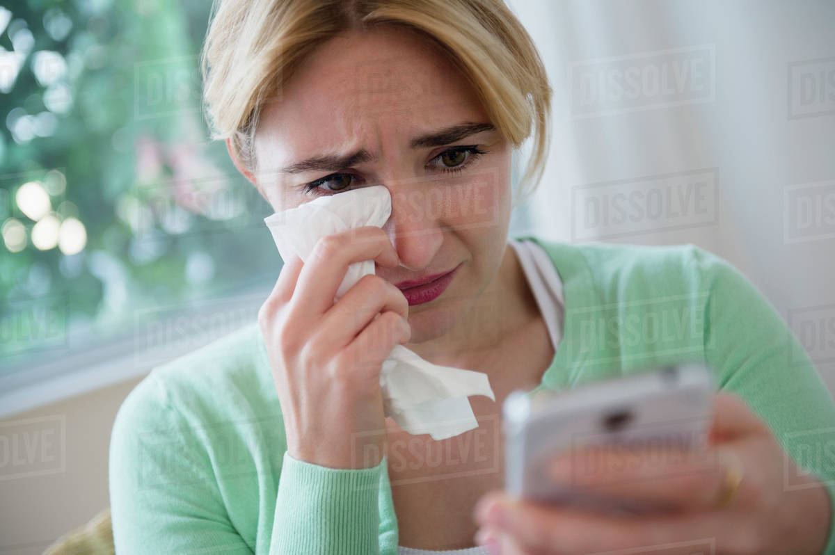 Crying Caucasian woman using cell phone - Royalty-free Stock Photo ...
