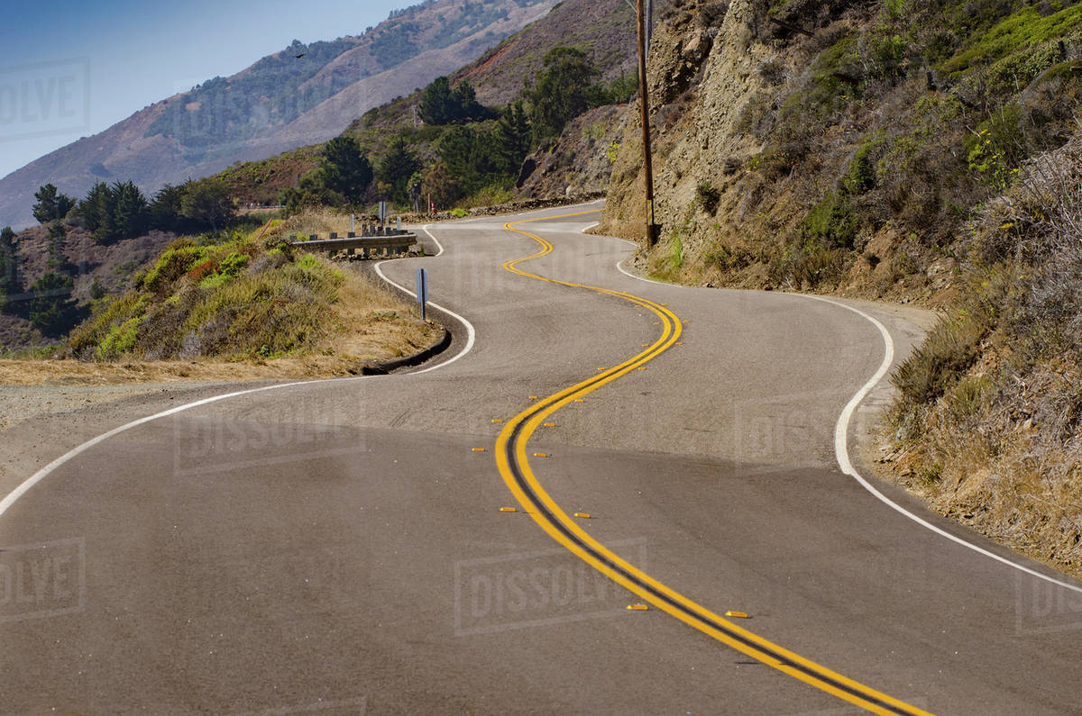 Empty road on remote hillside - Royalty-free Stock Photo | Dissolve