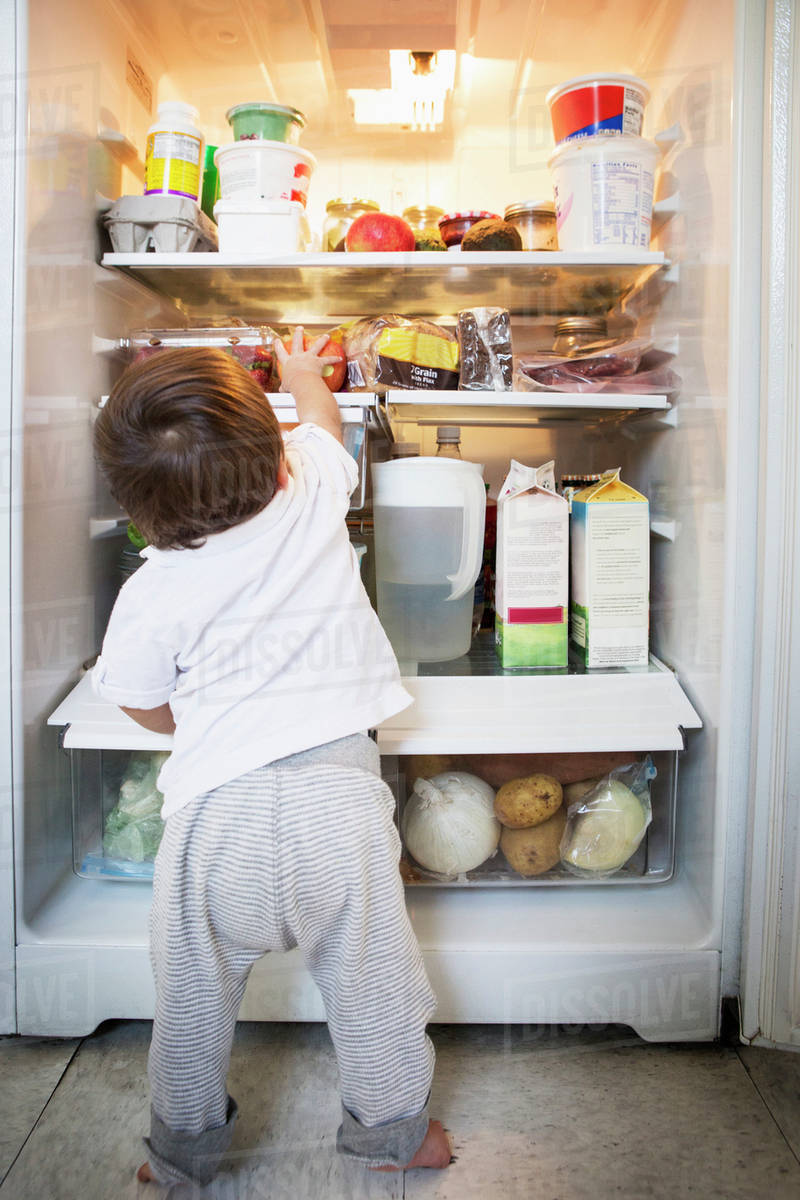Mixed race baby boy exploring refrigerator - Royalty-free Stock Photo ...