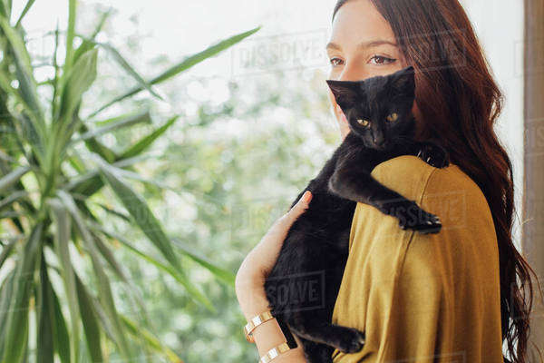 Caucasian woman holding kitten - Stock Photo - Dissolve