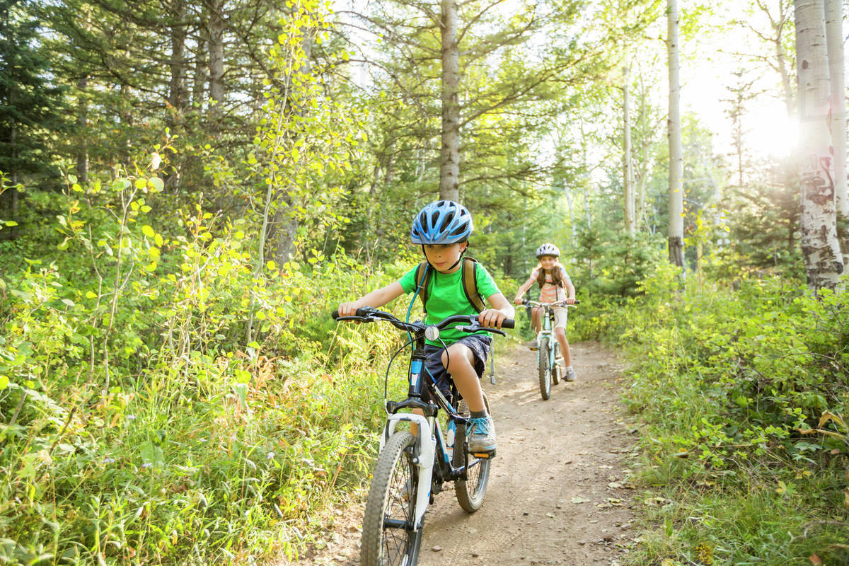 Caucasian children riding mountain bikes - Royalty-free Stock Photo ...
