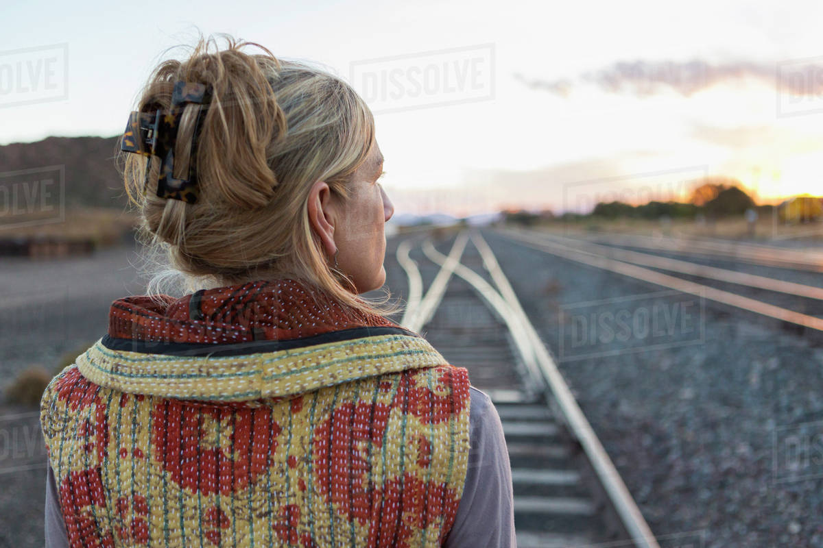 Caucasian woman standing on train tracks - Royalty-free Stock Photo ...