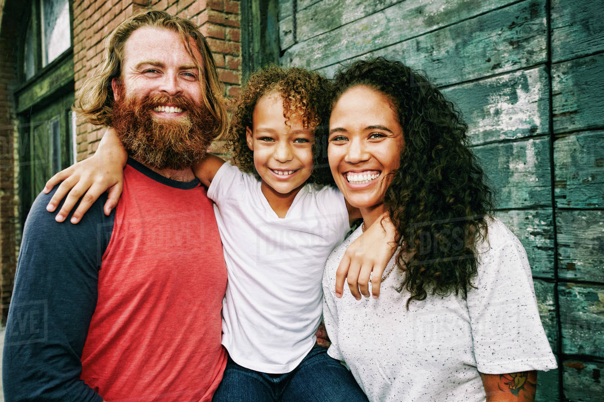 Family hugging outdoors - Royalty-free Stock Photo | Dissolve