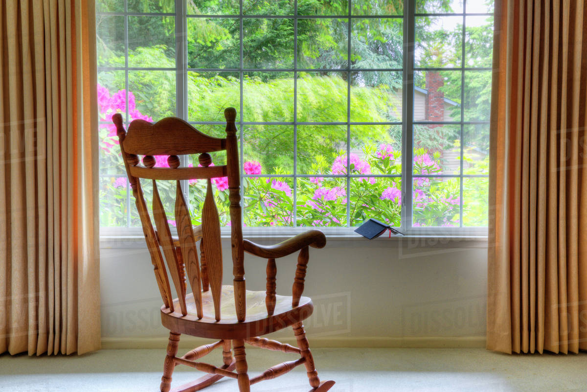 Rocking chair at living room window - Stock Photo - Dissolve