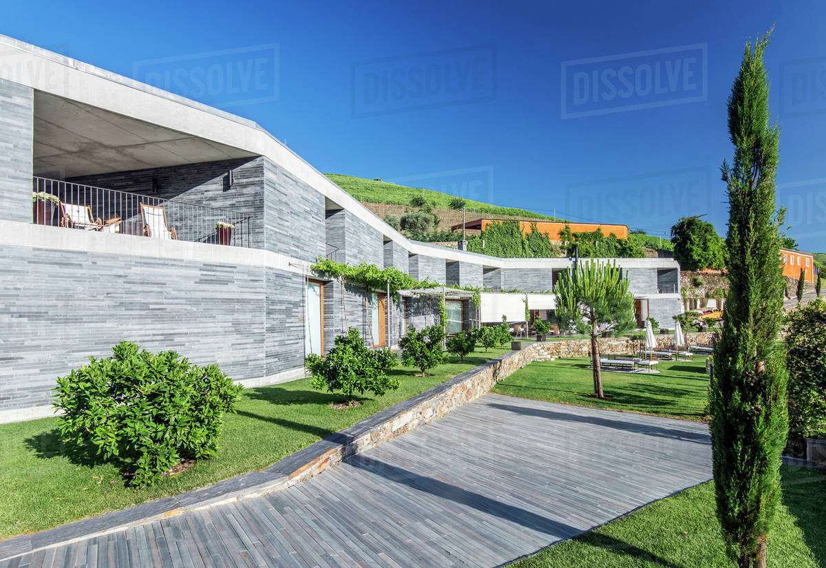 Modern hotel and wooden walkway - Royalty-free Stock Photo | Dissolve