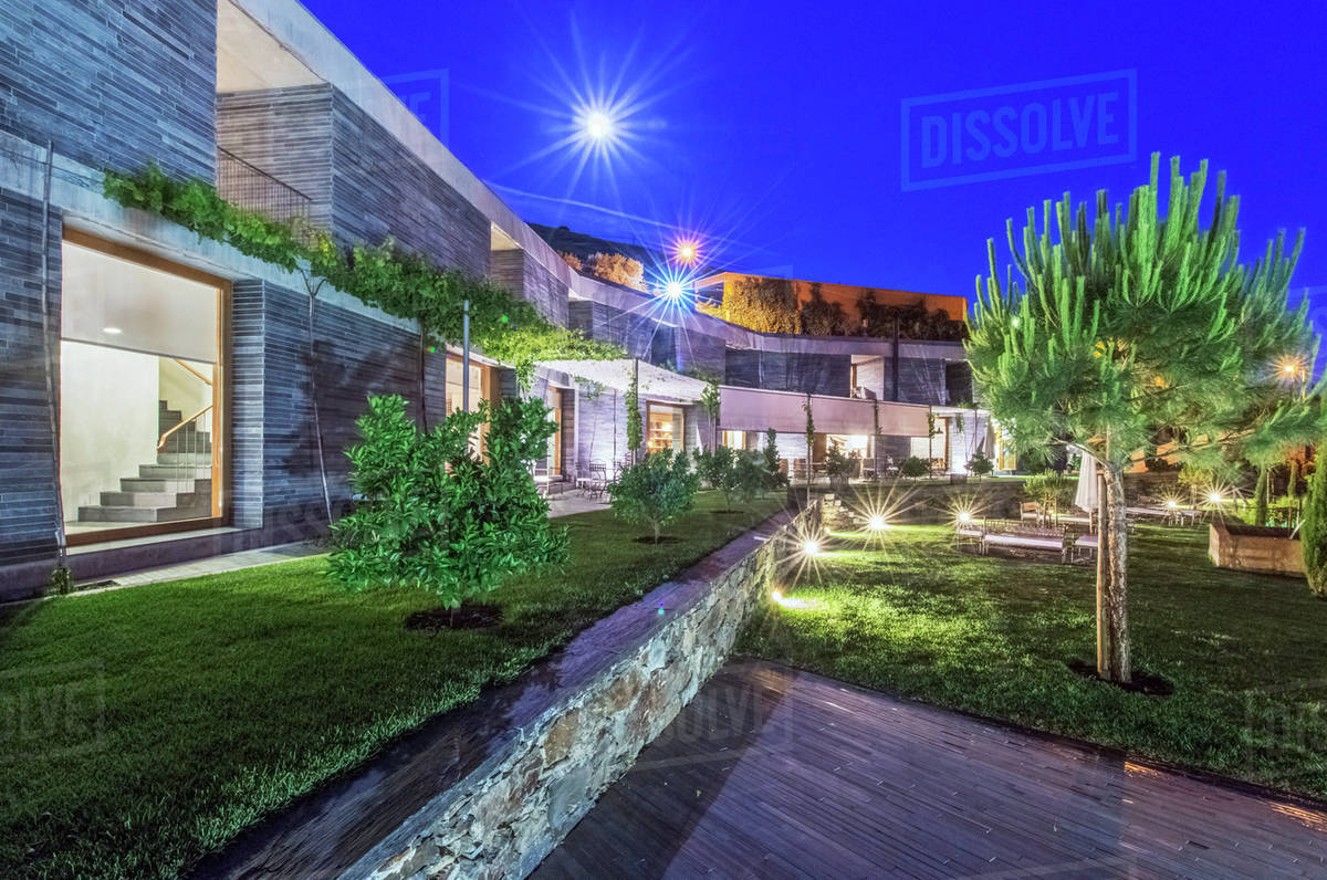 Modern hotel illuminated at night - Royalty-free Stock Photo | Dissolve