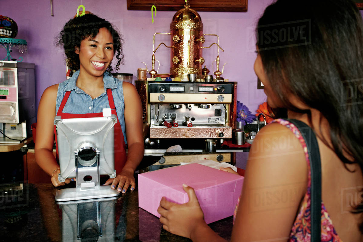 Cashier serving customer in bakery - Royalty-free Stock Photo | Dissolve