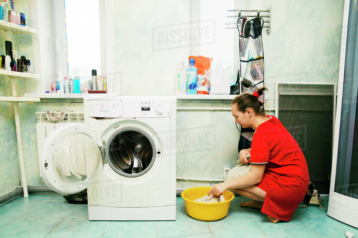 Caucasian woman hand-washing laundry - Royalty-free Stock Photo | Dissolve