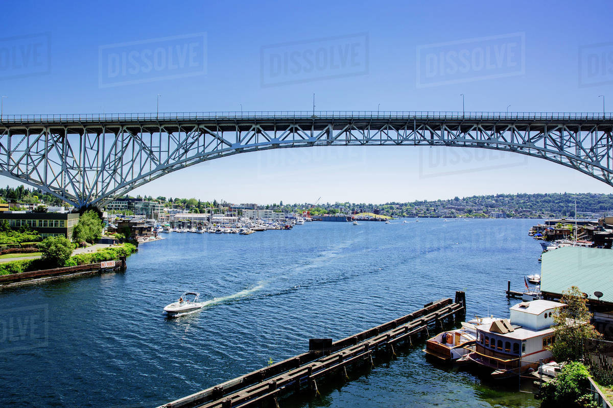 Blue sky and bridge over urban marina - Stock Photo - Dissolve