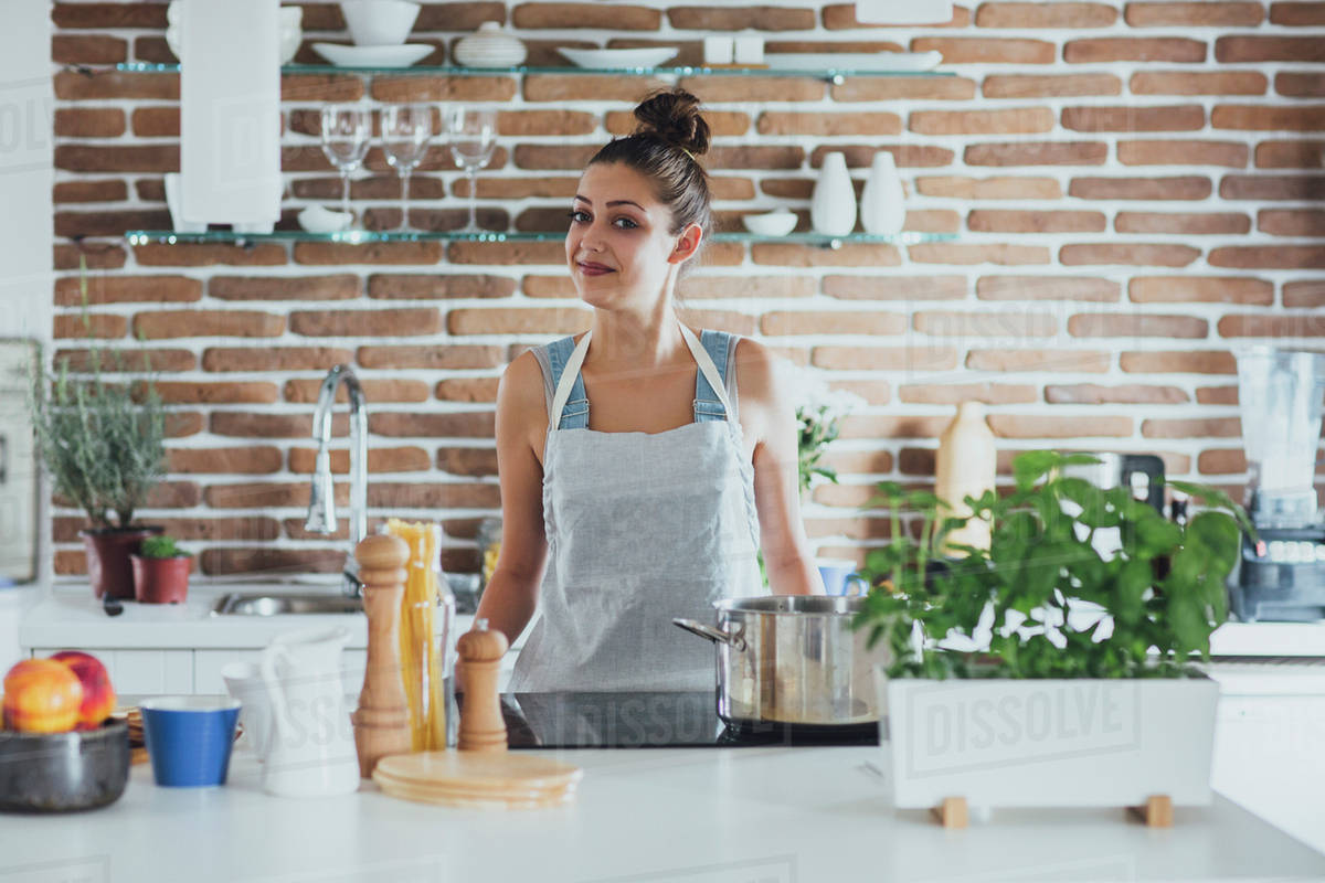 Caucasian woman cooking in kitchen - Royalty-free Stock Photo | Dissolve